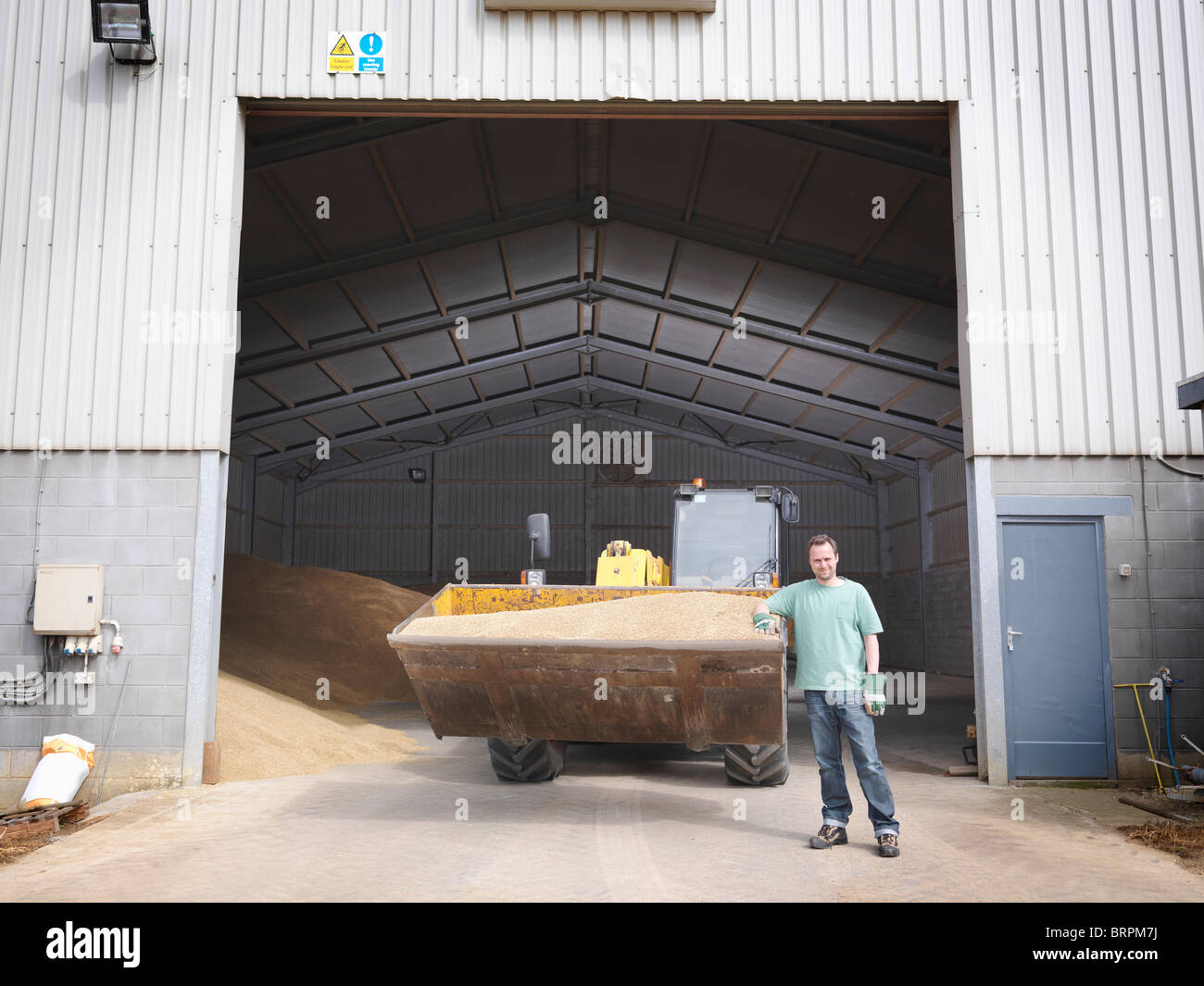 Farmer in front of grain store Stock Photo - Alamy