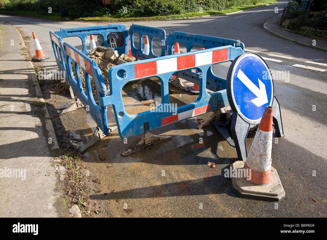 Burst Water Main In A Village Street Stock Photo - Alamy