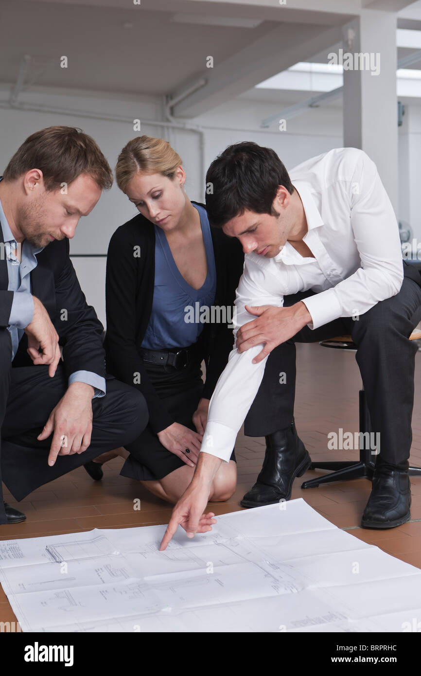 Business team reviewing specifications Stock Photo - Alamy Business team reviewing specifications Stock Photo - Alamy