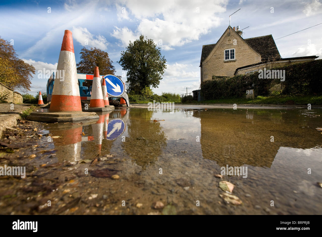 Burst Water Main In A Village Street Stock Photo - Alamy