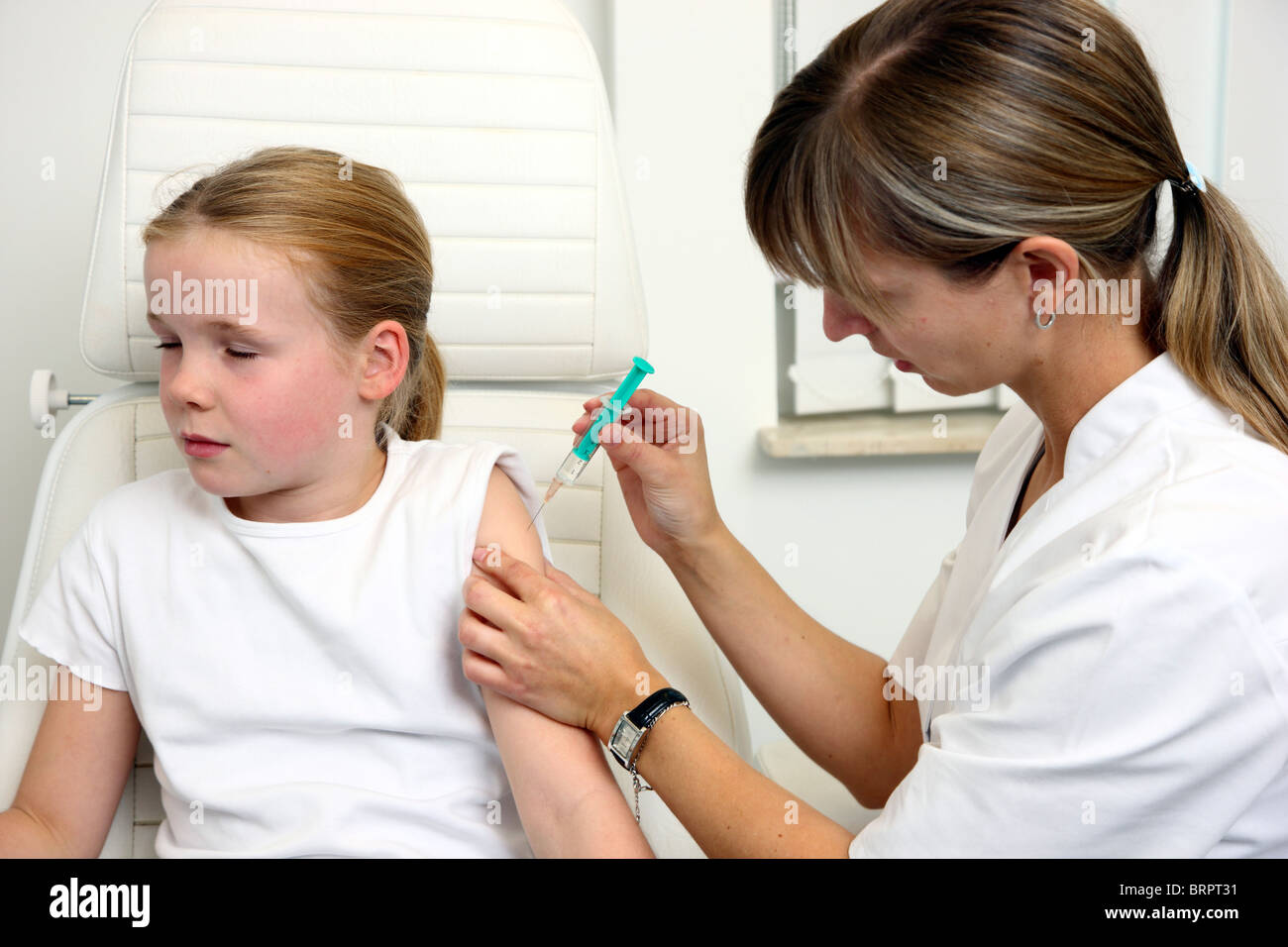 Medical practice, young girl having a injection Stock Photo - Alamy