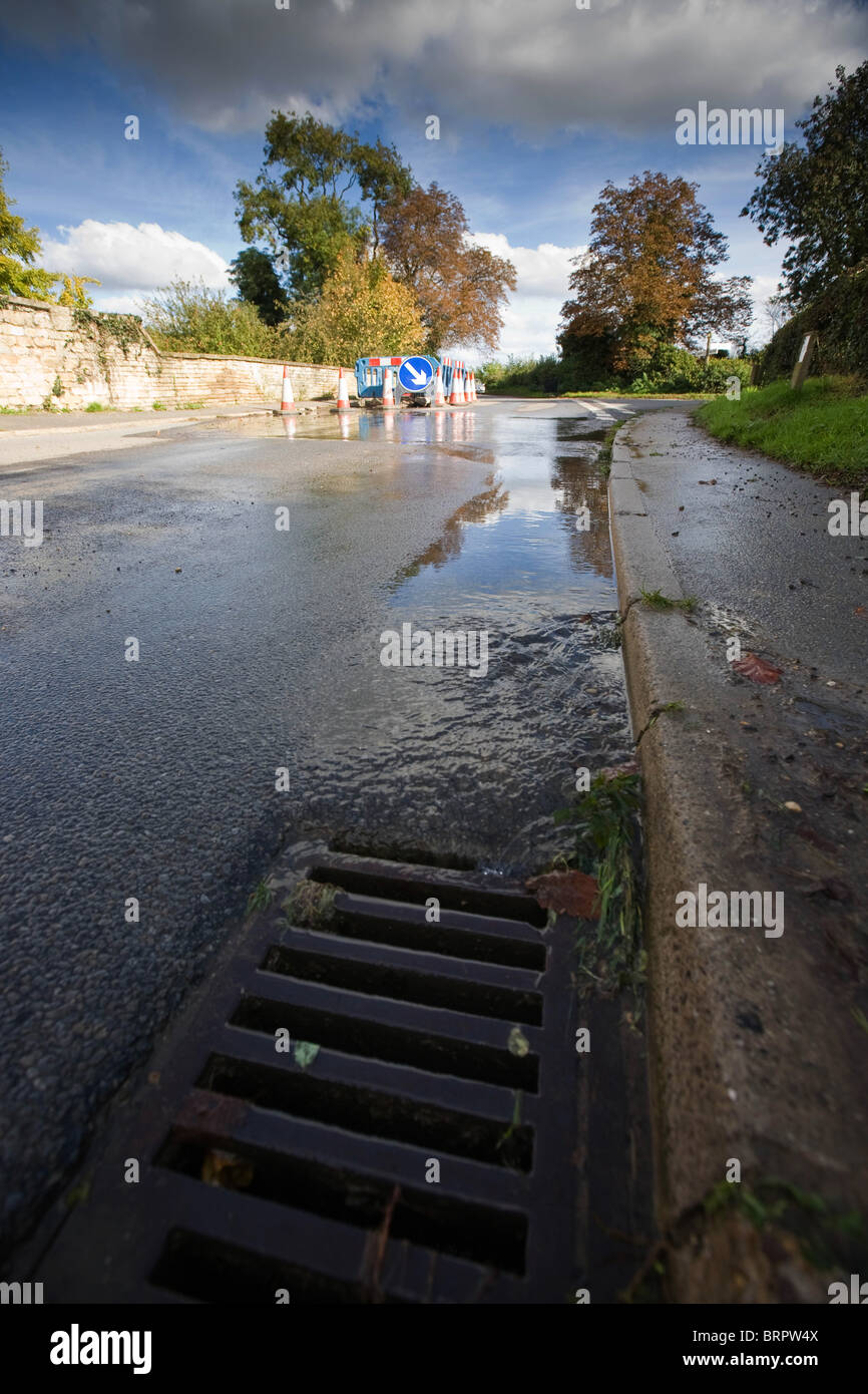 Burst Water Main In A Village Street Stock Photo - Alamy