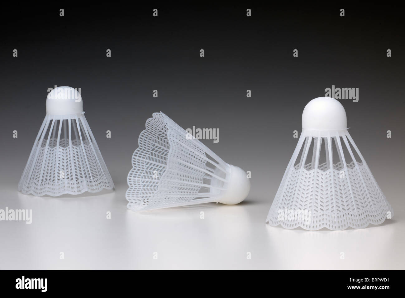 Three white plastic shuttlecocks Stock Photo - Alamy