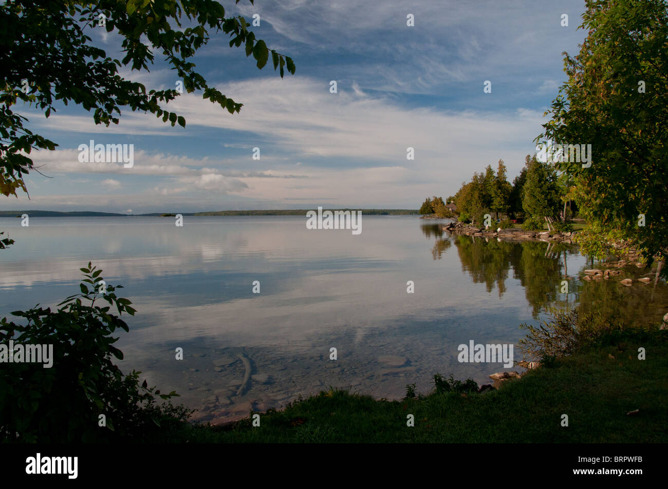 The sky reflected in Lake Manitou Stock Photo - Alamy