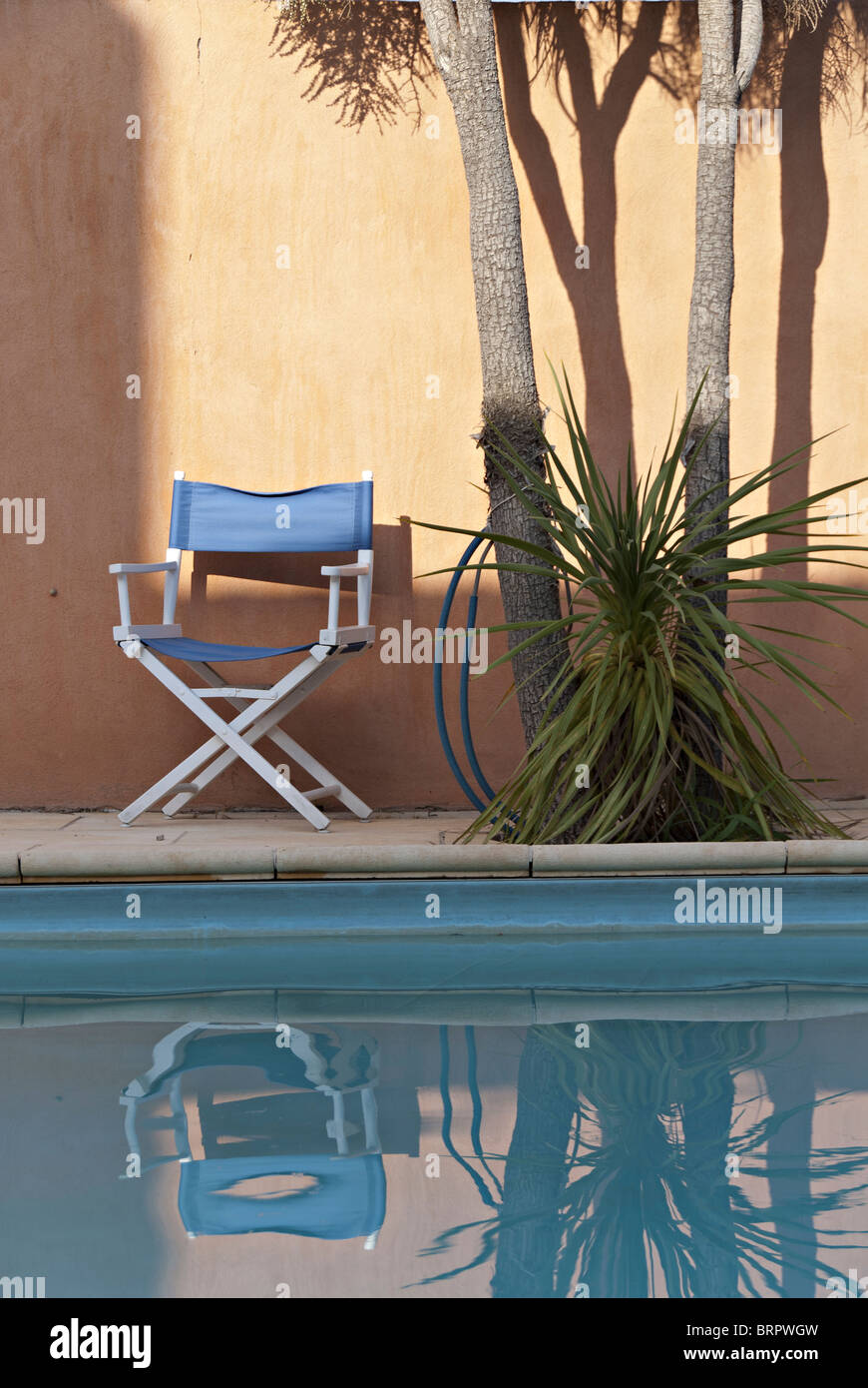 swimming poolside and director chair Stock Photo - Alamy