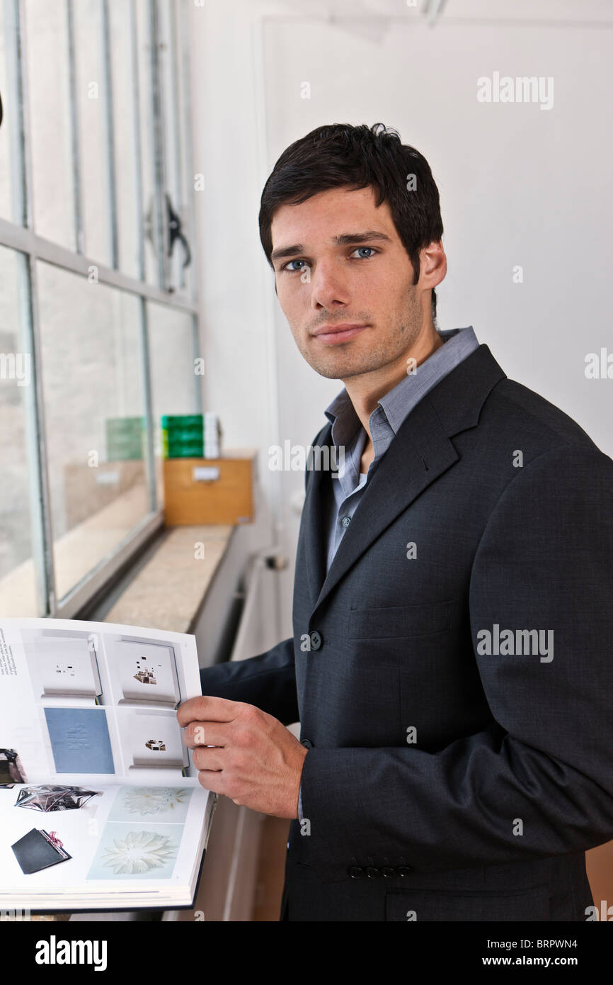 Business man reviewing a catalogue Stock Photo - Alamy