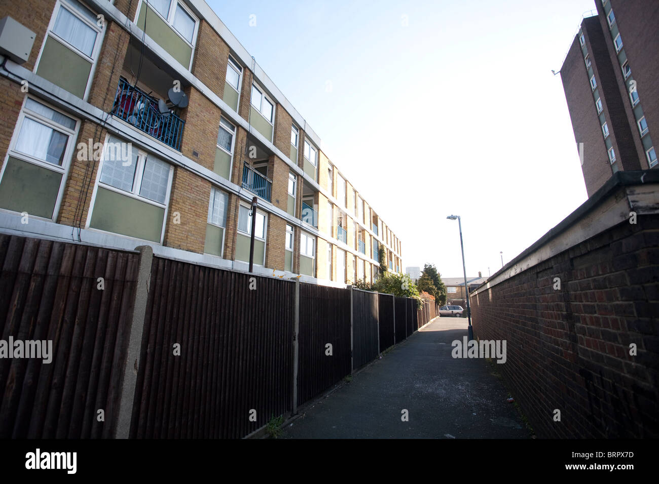 Alley way between urban council estate block of flats in Canning Town ...