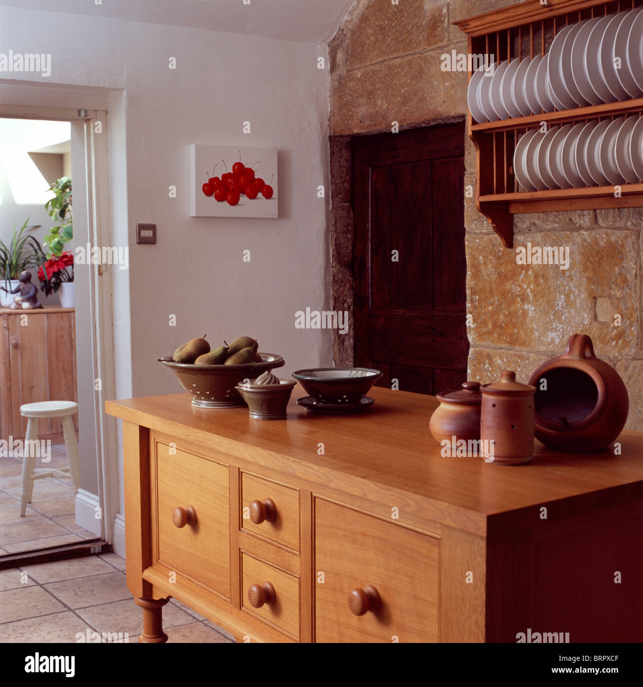 Wood sideboard below plate-rack in country kitchen Stock Photo - Alamy