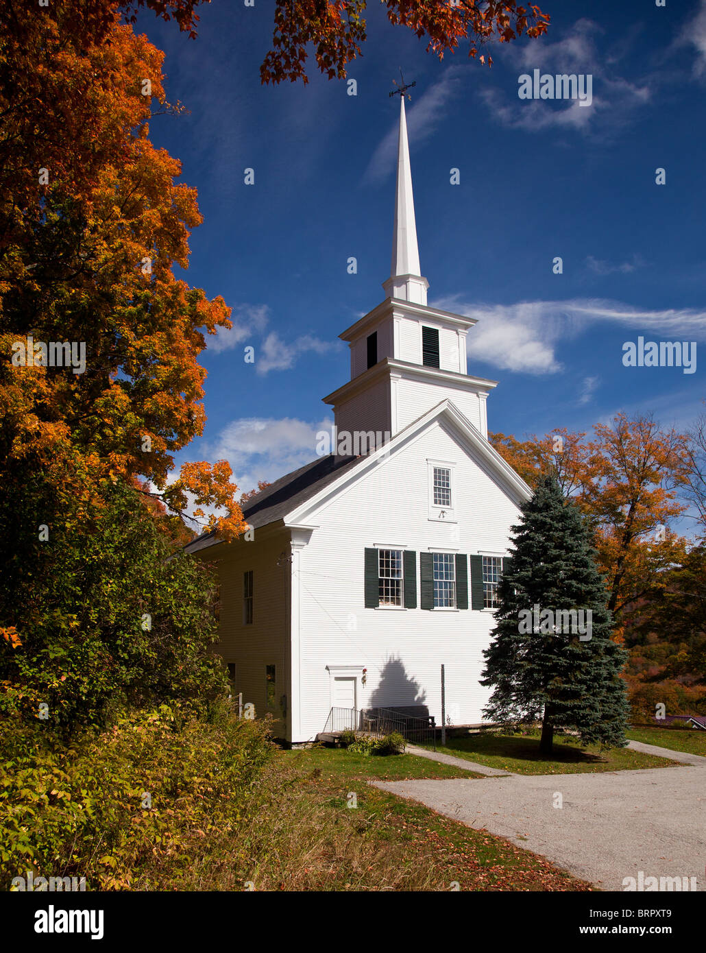 Autumnal shot of the typical Vermont church in fall as the bright trees ...