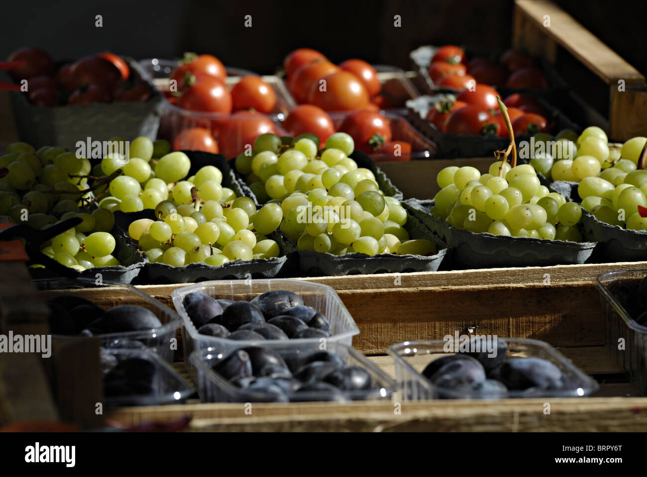 Fruit stall with plum tomatoes and grapes boxes Stock Photo - Alamy