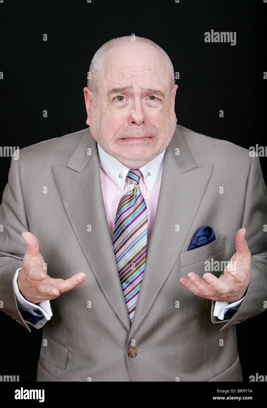 middle aged businessman looking distressed or confused over black ...