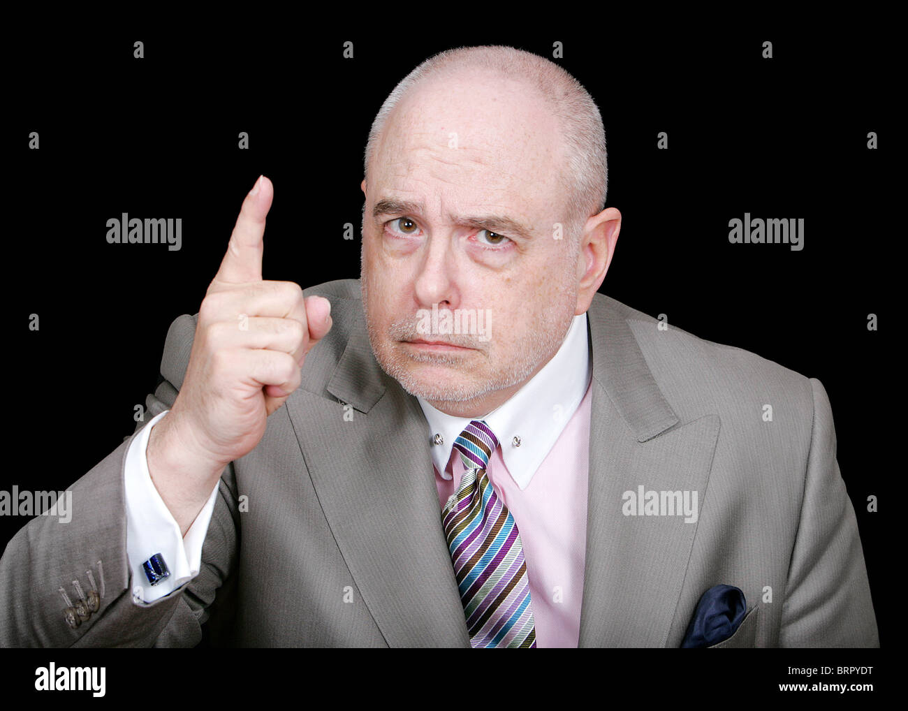 a middle aged business executive pointing a finger over a black ...