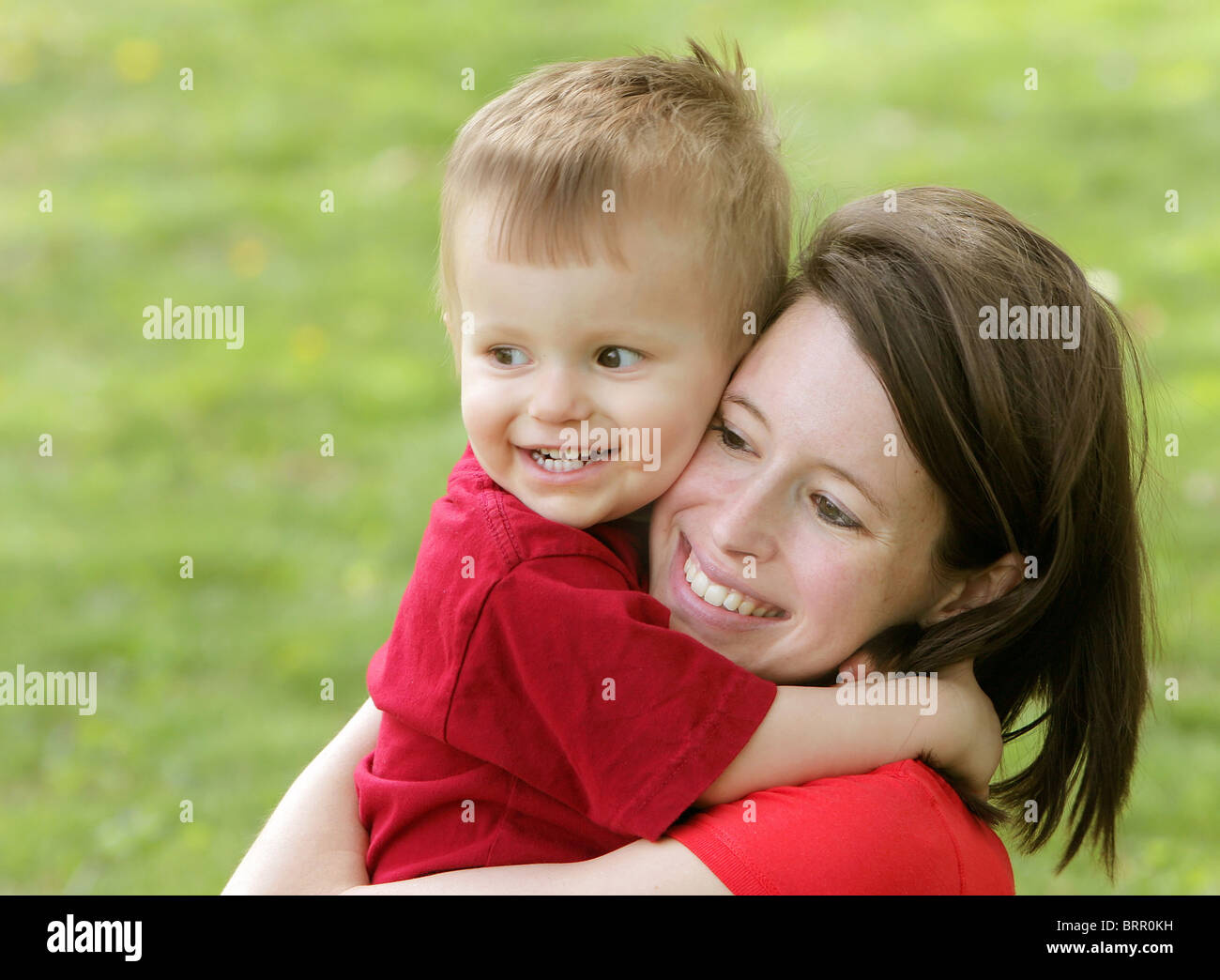 close up portrait headshot of a mother and son smiling and hugging each ...