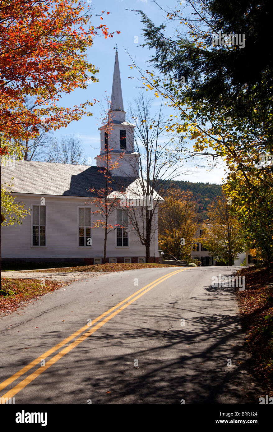 Autumnal shot of the typical Vermont church in fall as the bright trees ...