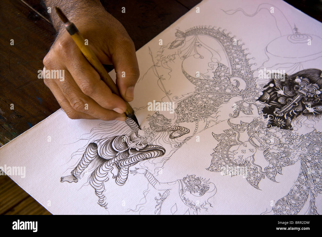 Indonesian artist at work on a traditional painting Stock Photo - Alamy