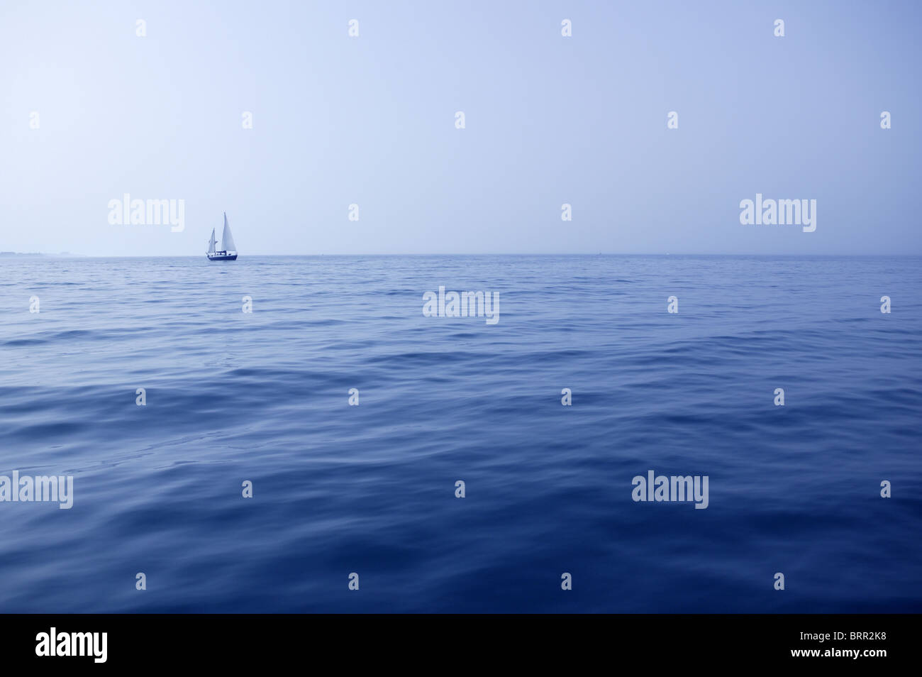 Blue sea with sailboat sailing the ocean surface summer vacation Stock ...