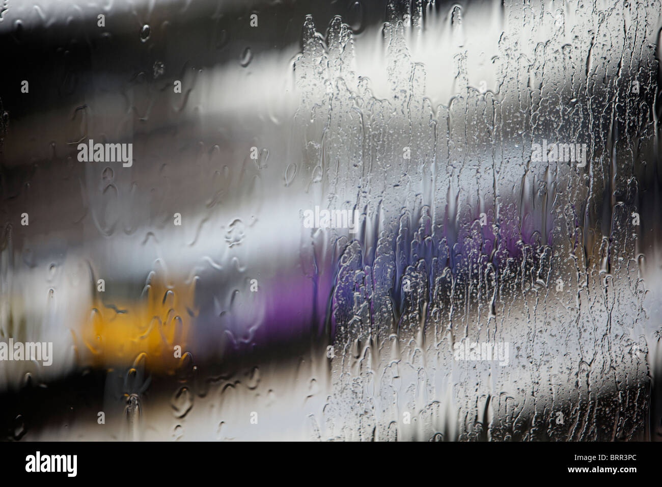 Rain falls on a window pane as a train pulls into Sheffield railway ...