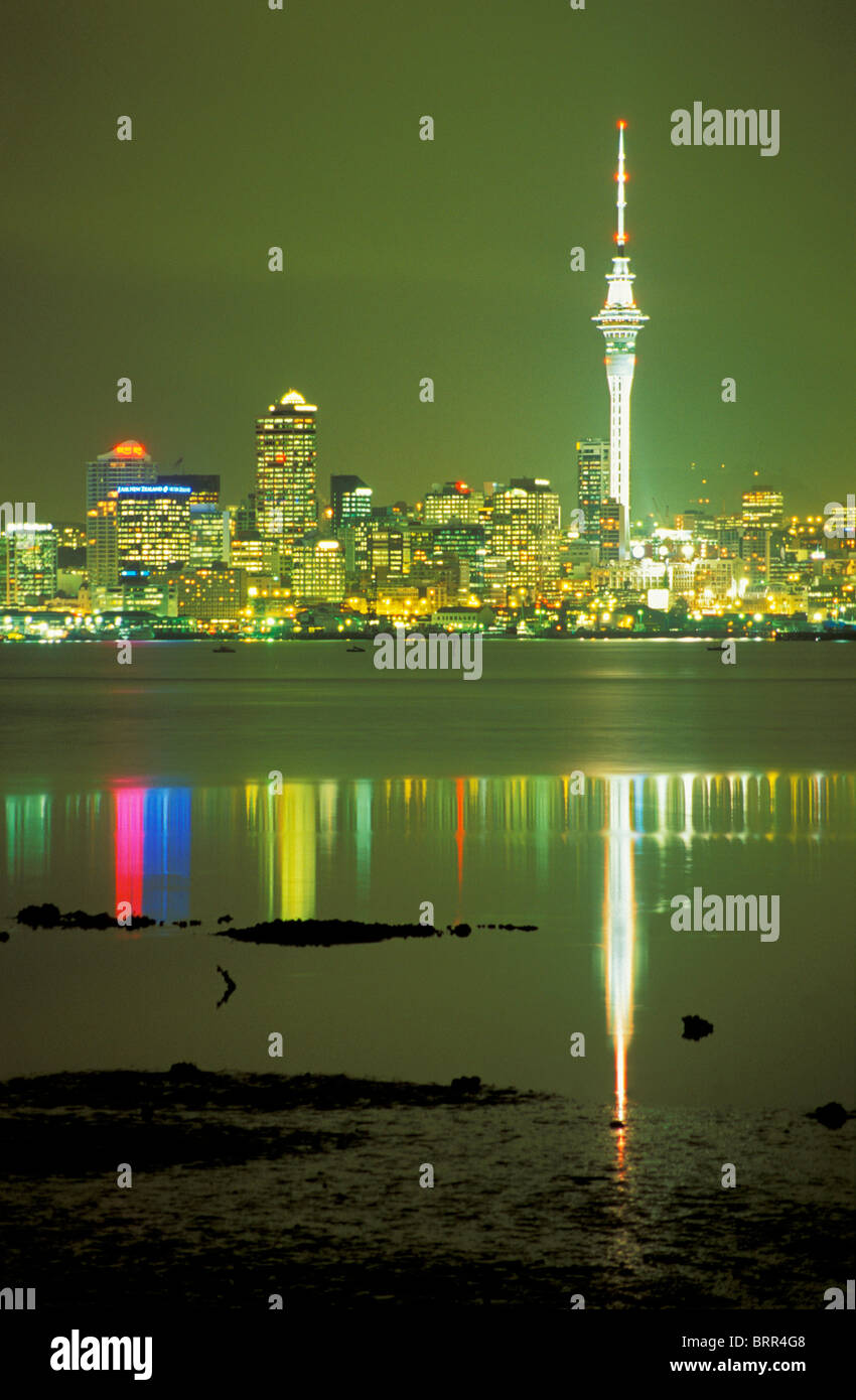 Auckland city skyline at night with brightly illuminated Sky Tower ...