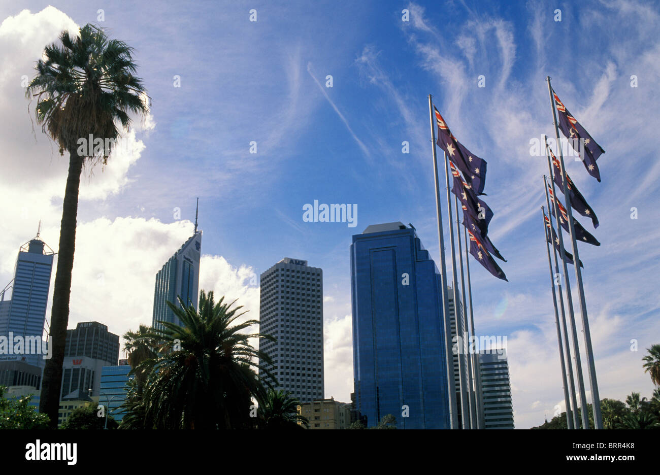 Low angle view of skyscrapers and flags blowing in the wind Stock Photo ...