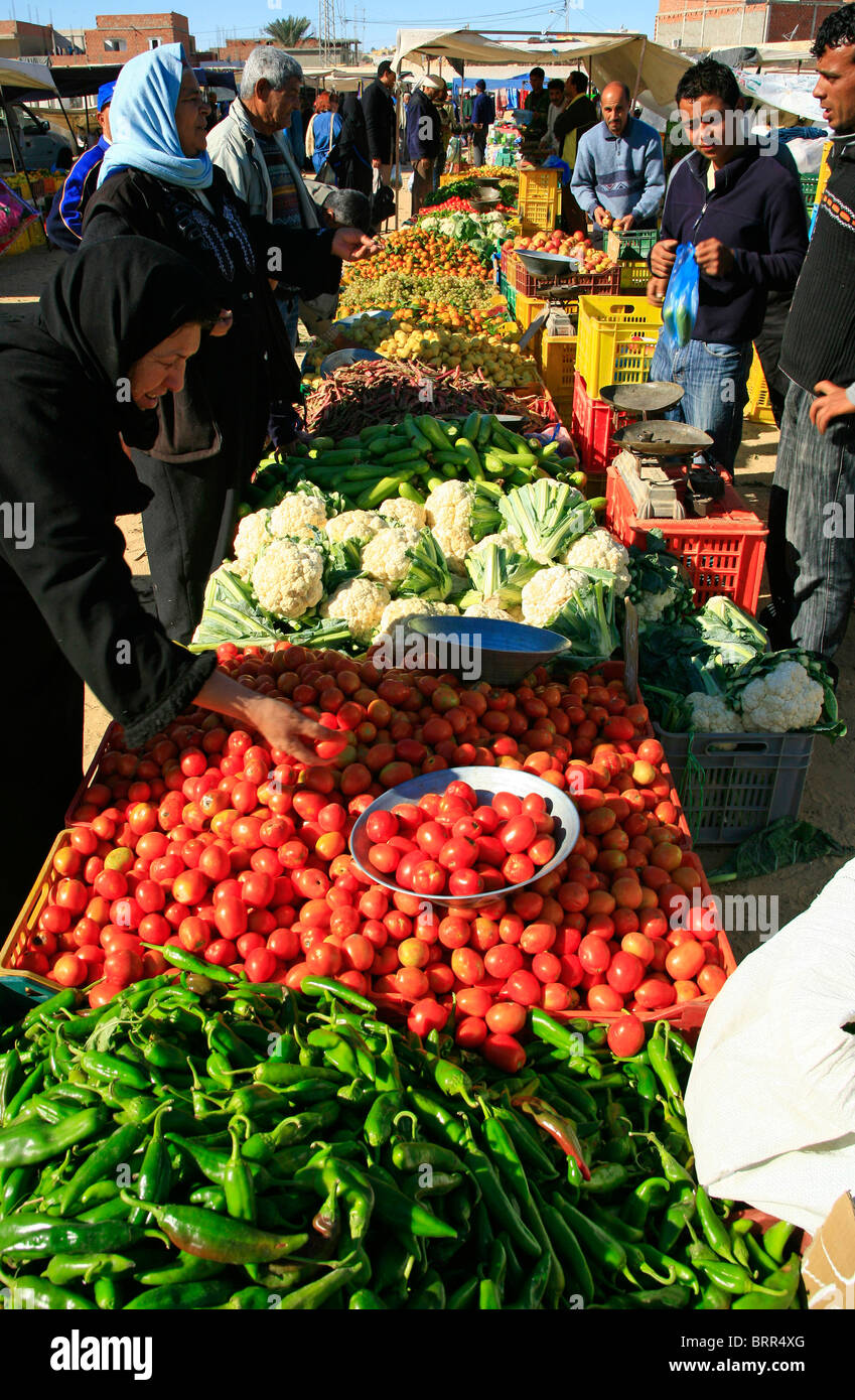 Muslim women buy fruit and vegetables at the local market Stock Photo ...
