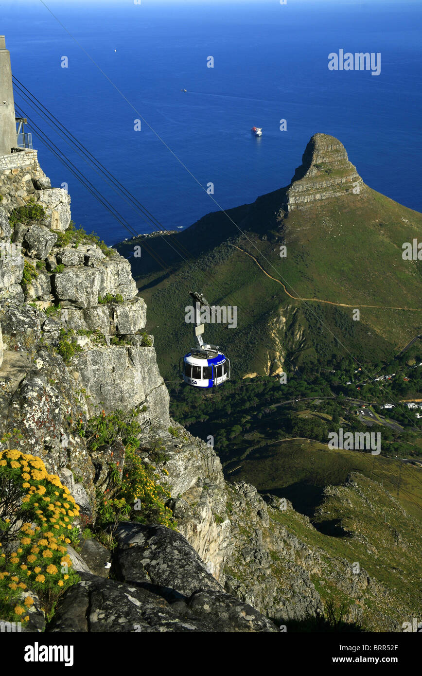 Table Mountain cableway with Lions Head and Atlantic Ocean in the back ...