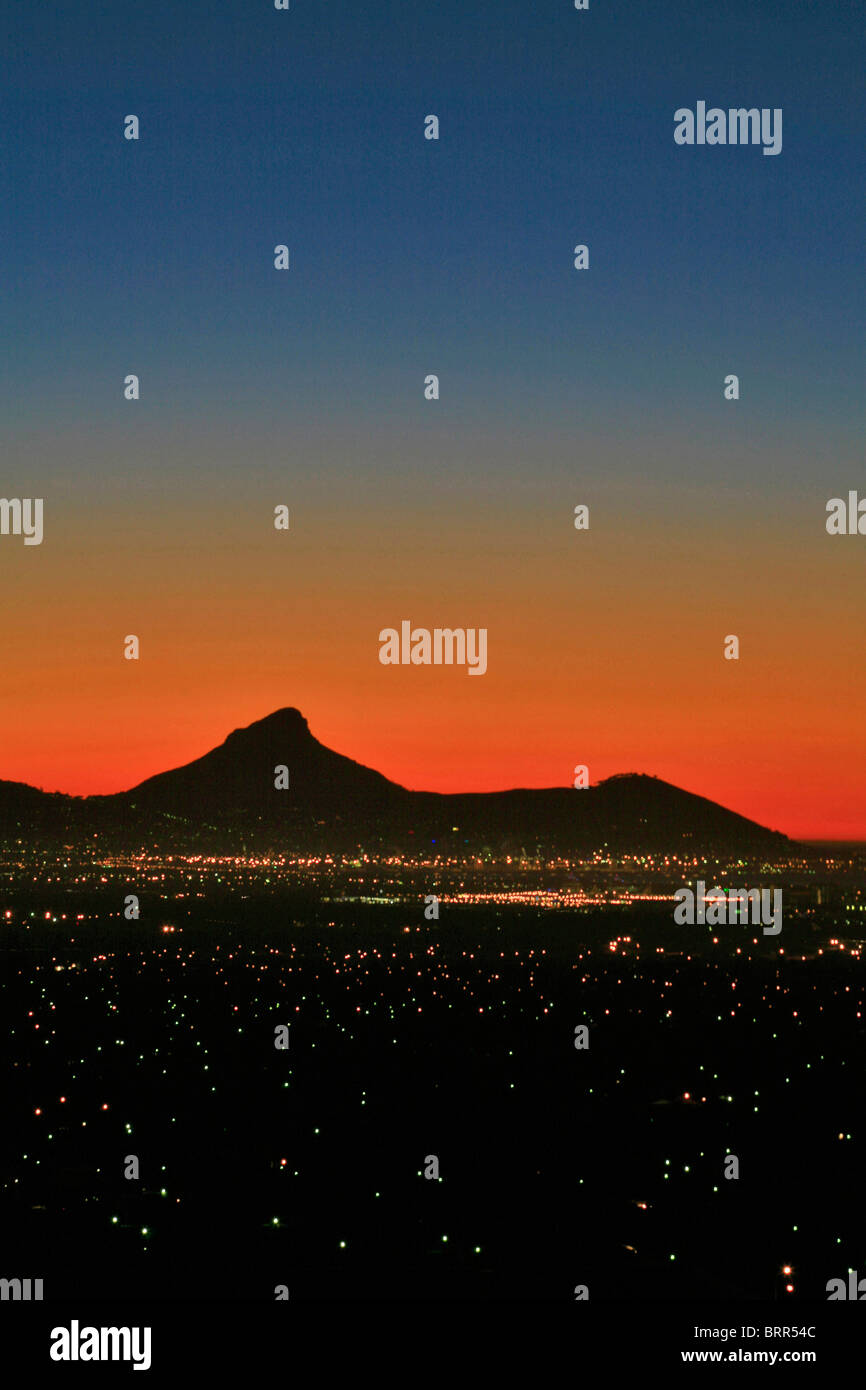 View over Cape Town city lights at sunset with Lions Head in the ...