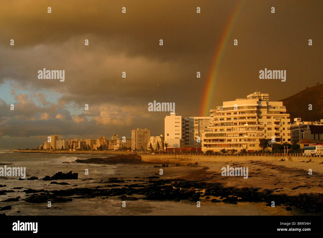 Rainbow over Sea Point beachfront and the Atlantic Ocean Stock Photo ...