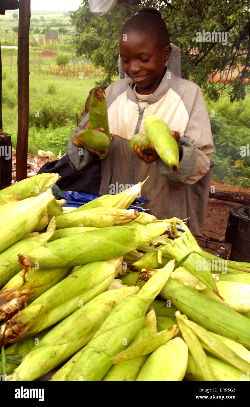 Young girl selling mielies at roadside stall Stock Photo - Alamy