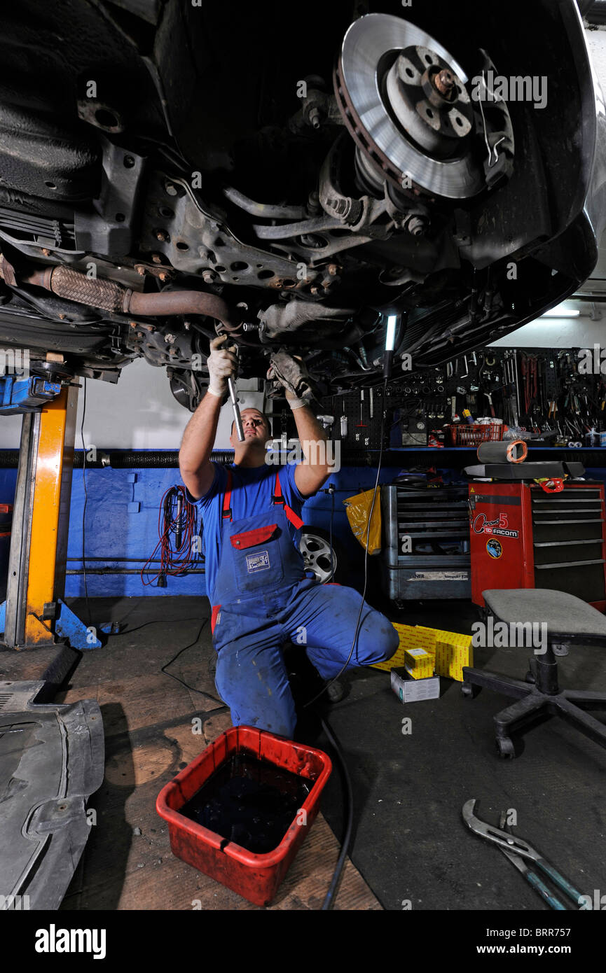 Car workshop with mechanic at work Stock Photo - Alamy