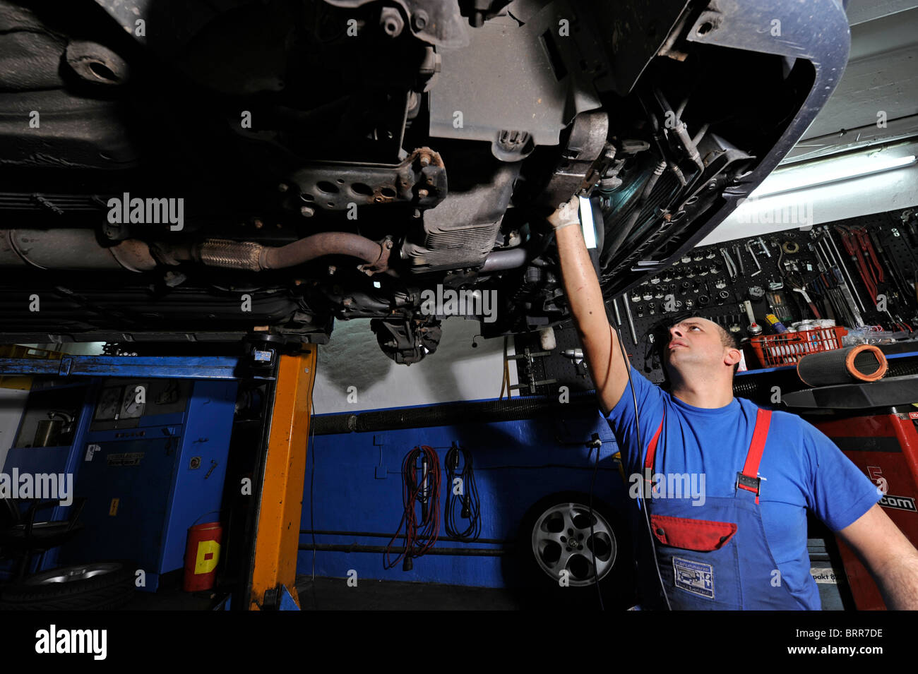 Car workshop with mechanic at work Stock Photo - Alamy