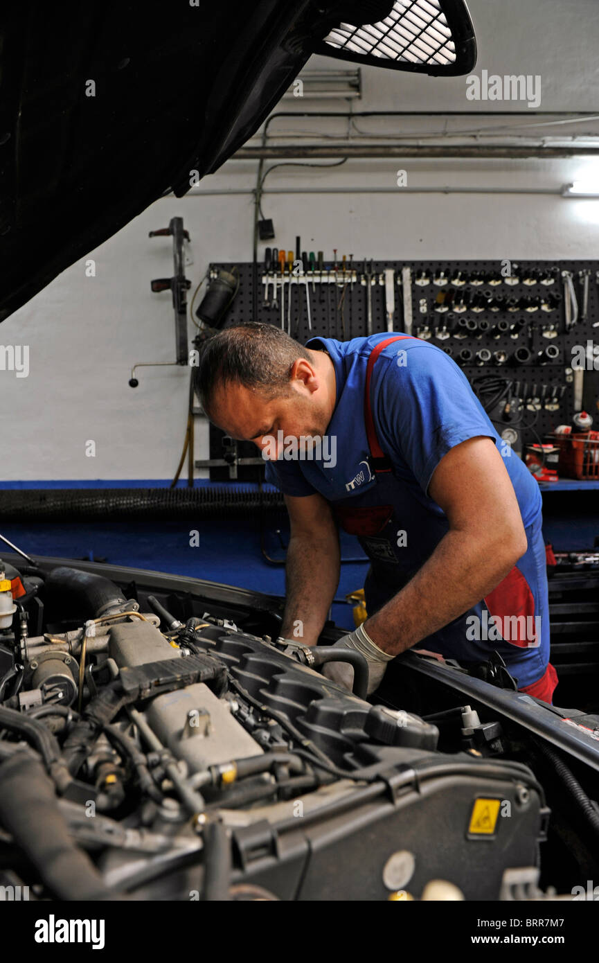 Car workshop with mechanic at work Stock Photo - Alamy