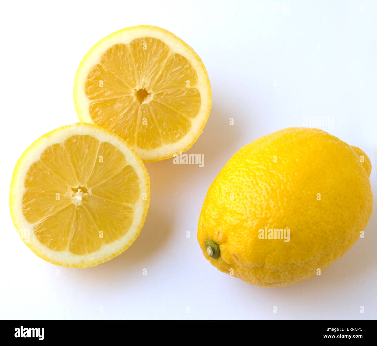 a lemon cut in half and a whole lemon Stock Photo - Alamy