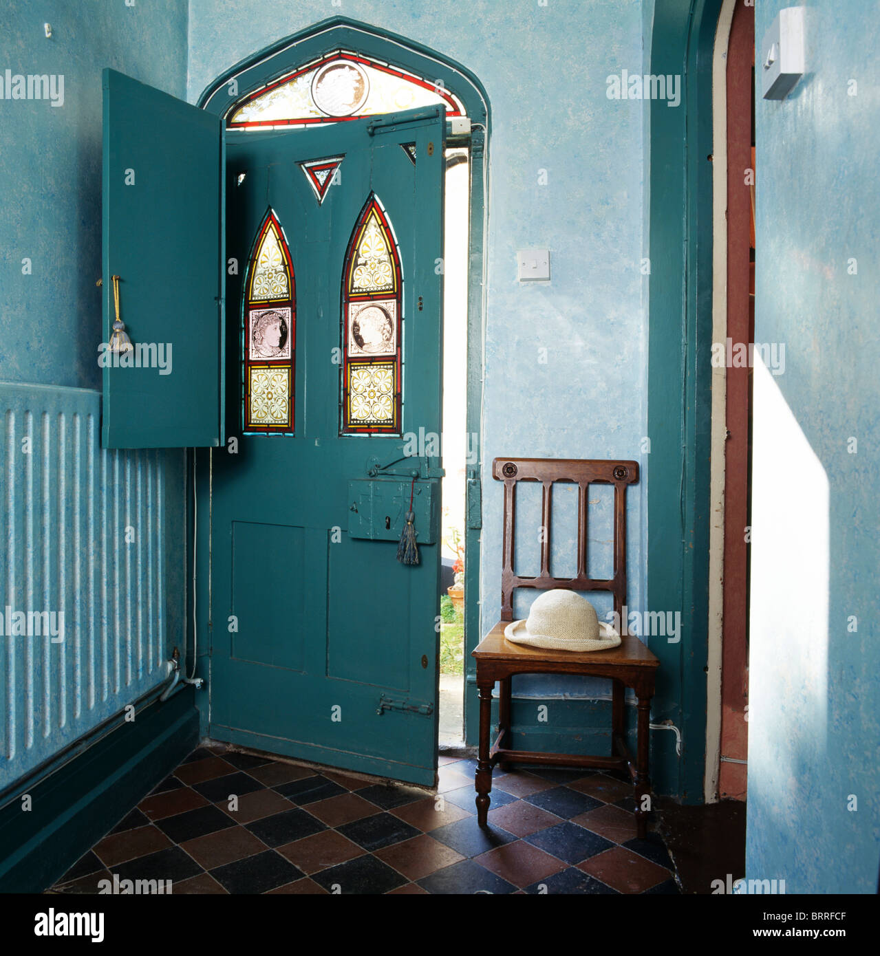Turquoise Gothic-style door with shutter and stained glass panels in ...