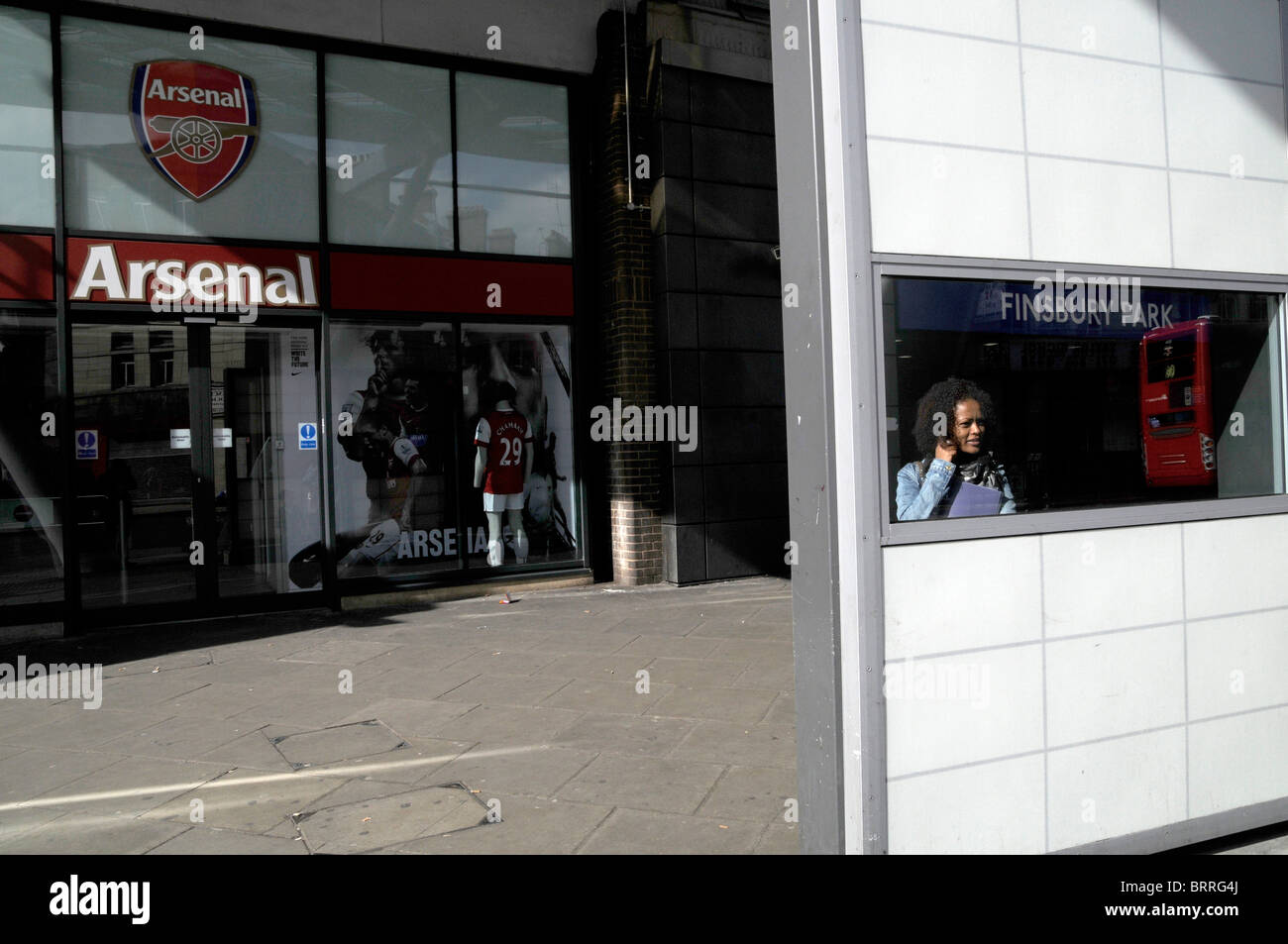 PASSENGER WAITING FOR BUS AT FINSBURY PARK STATION NEAR ARSENAL ...