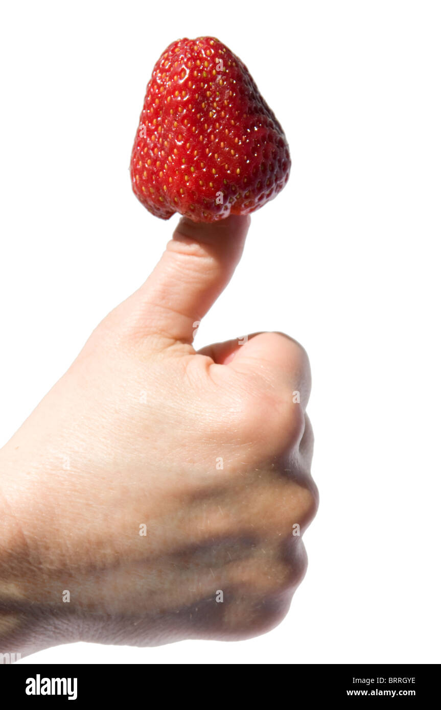 a strawberry stuck in a thumb Stock Photo - Alamy