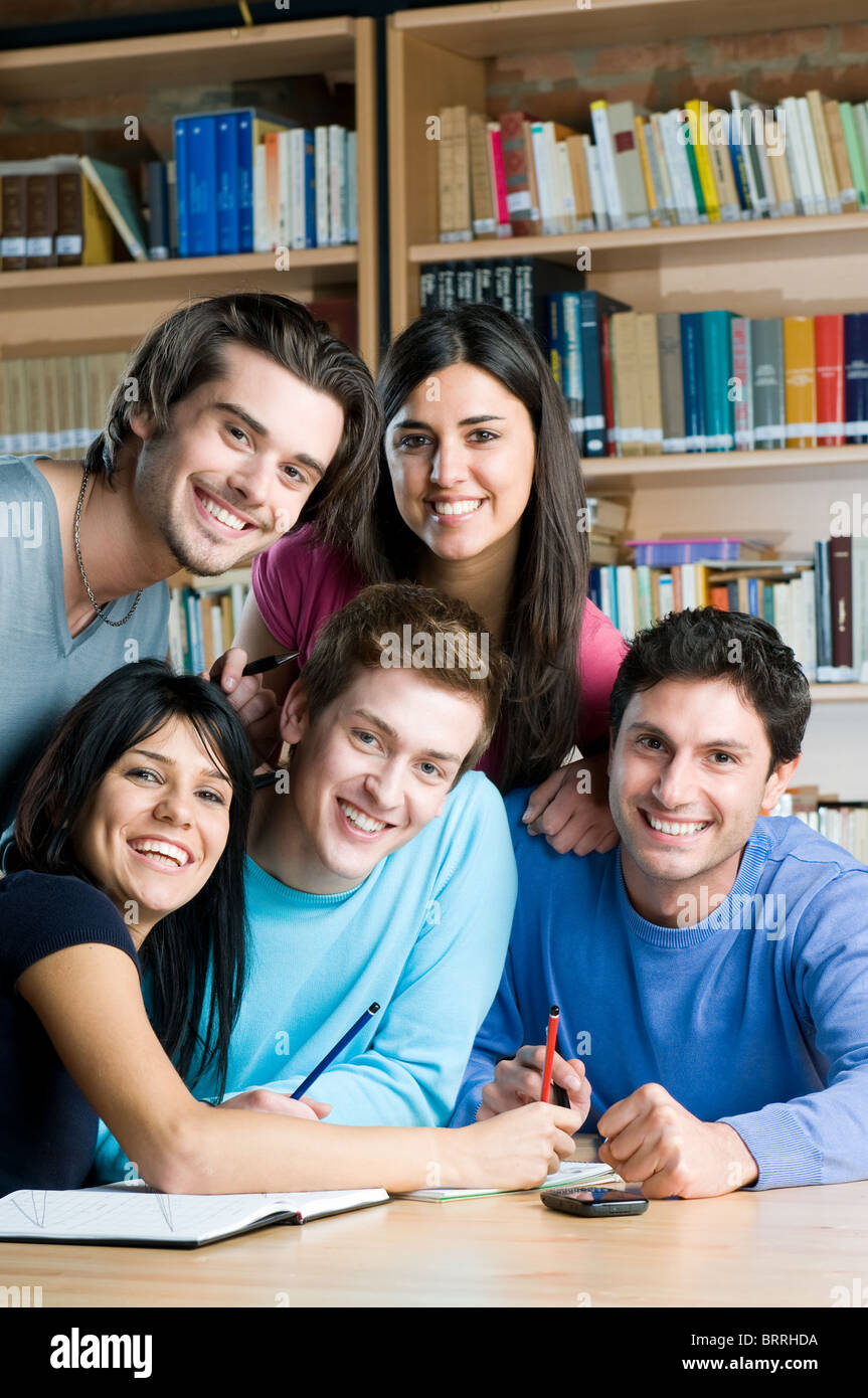 Smiling happy students studying together in a college library Stock ...