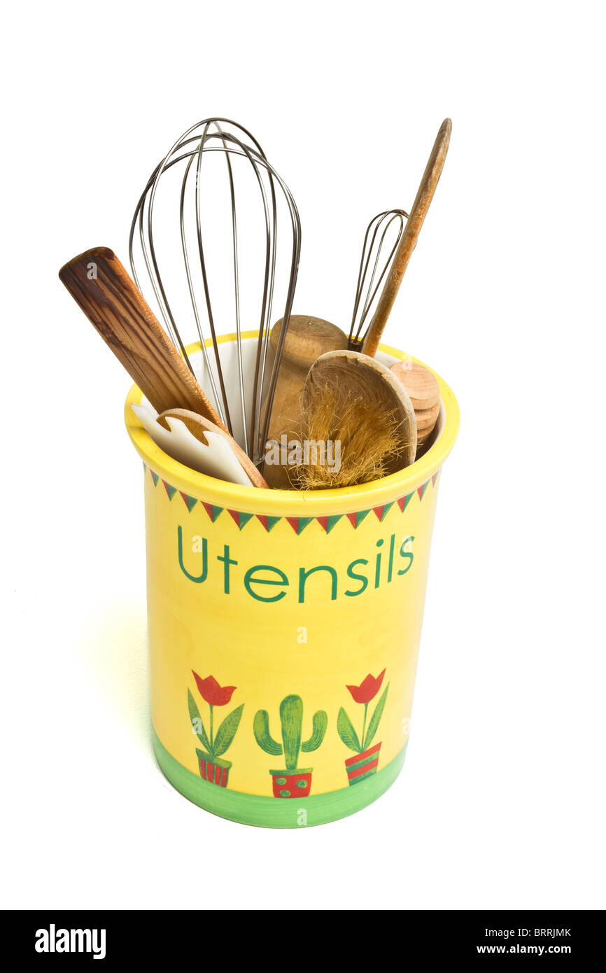 A selection of Kitchen Utensils in ceramic pot isolated on white Stock ...
