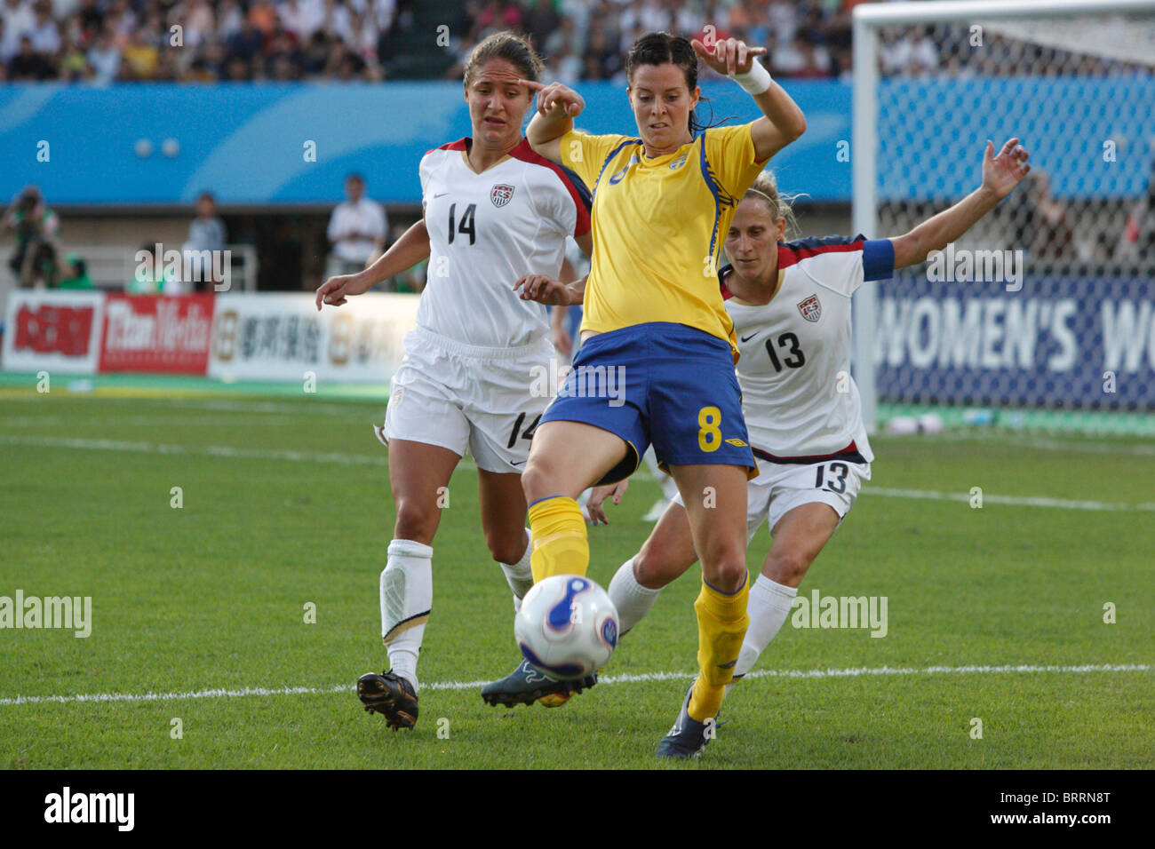 Lotta Schelin of Sweden (8) kicks the ball as Stephanie Lopez (14) and ...