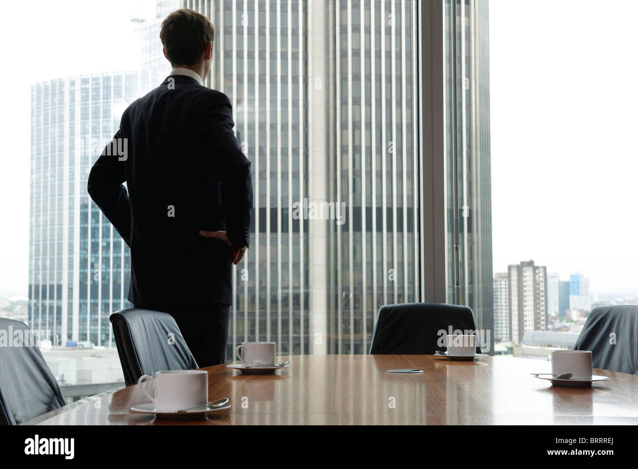 Single adult business man waiting for meeting to begin in Board room ...