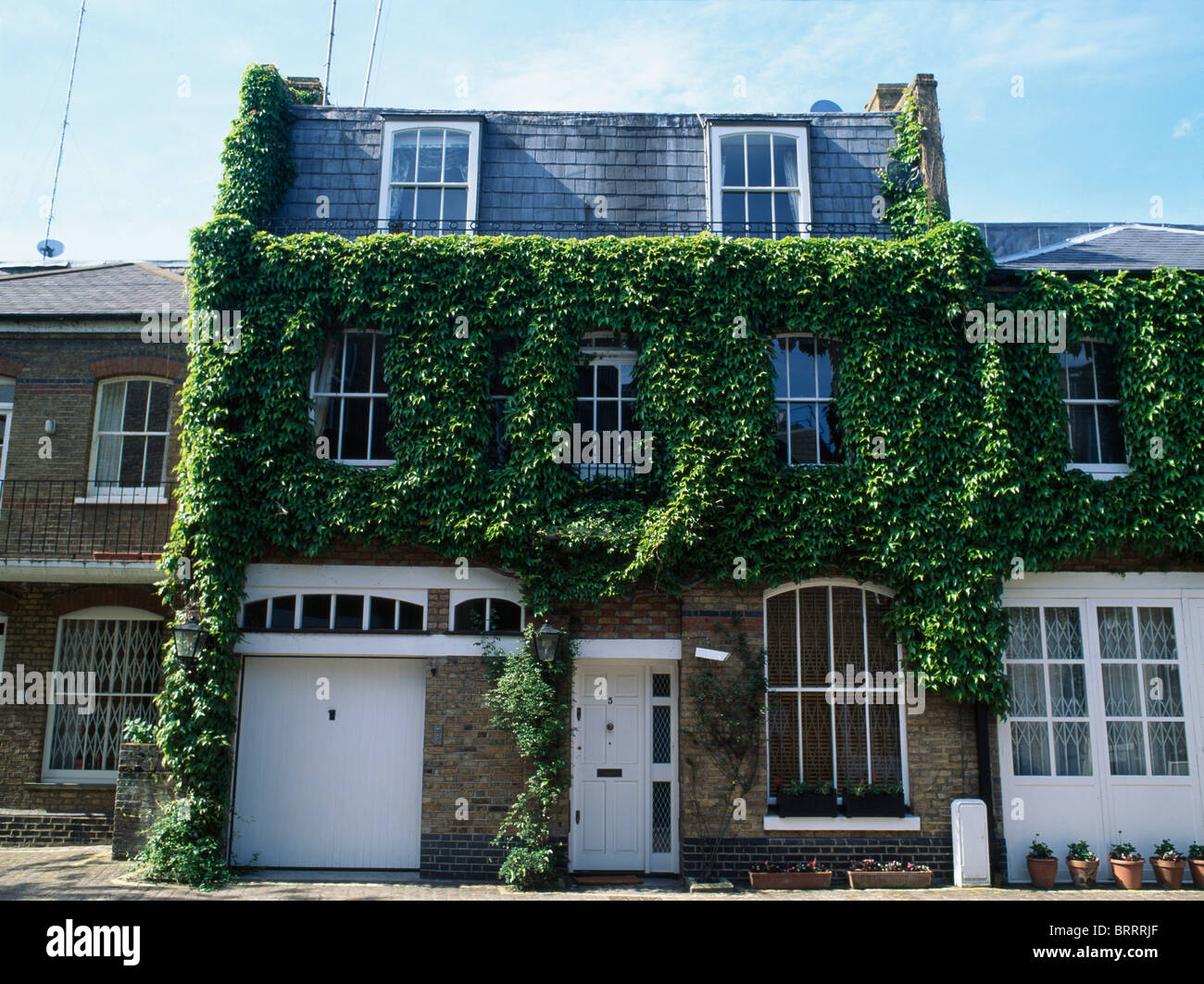 White doors on integral garage of traditional terraced townhouse ...