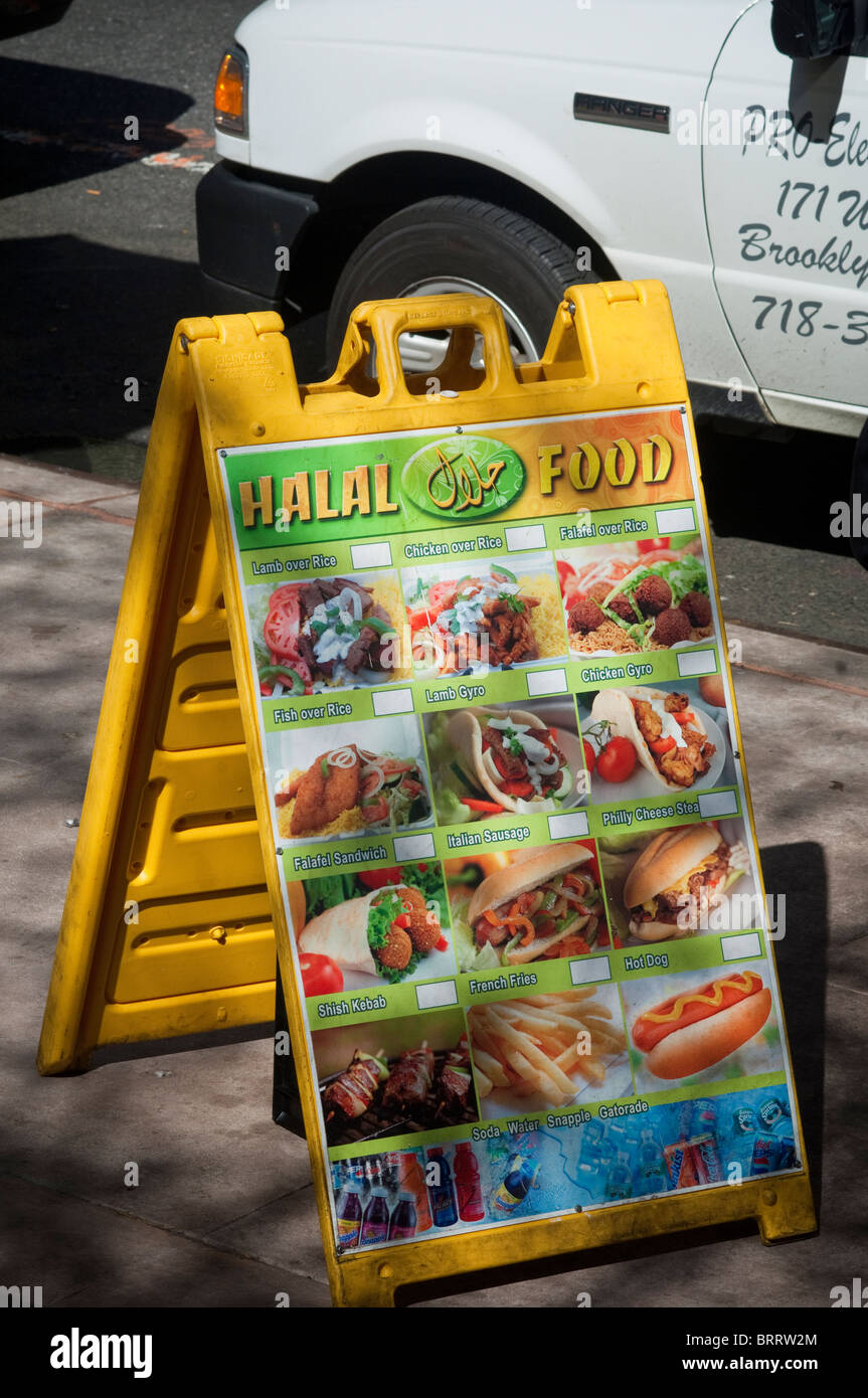 A sign advertises Halal food is served at a vendor's cart in Midtown in ...