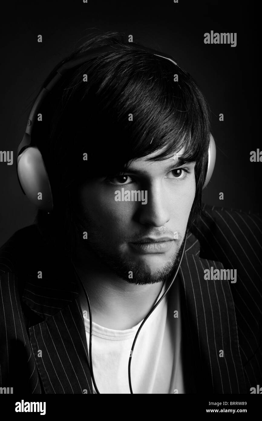 Young Man listening to music with headphones Stock Photo - Alamy