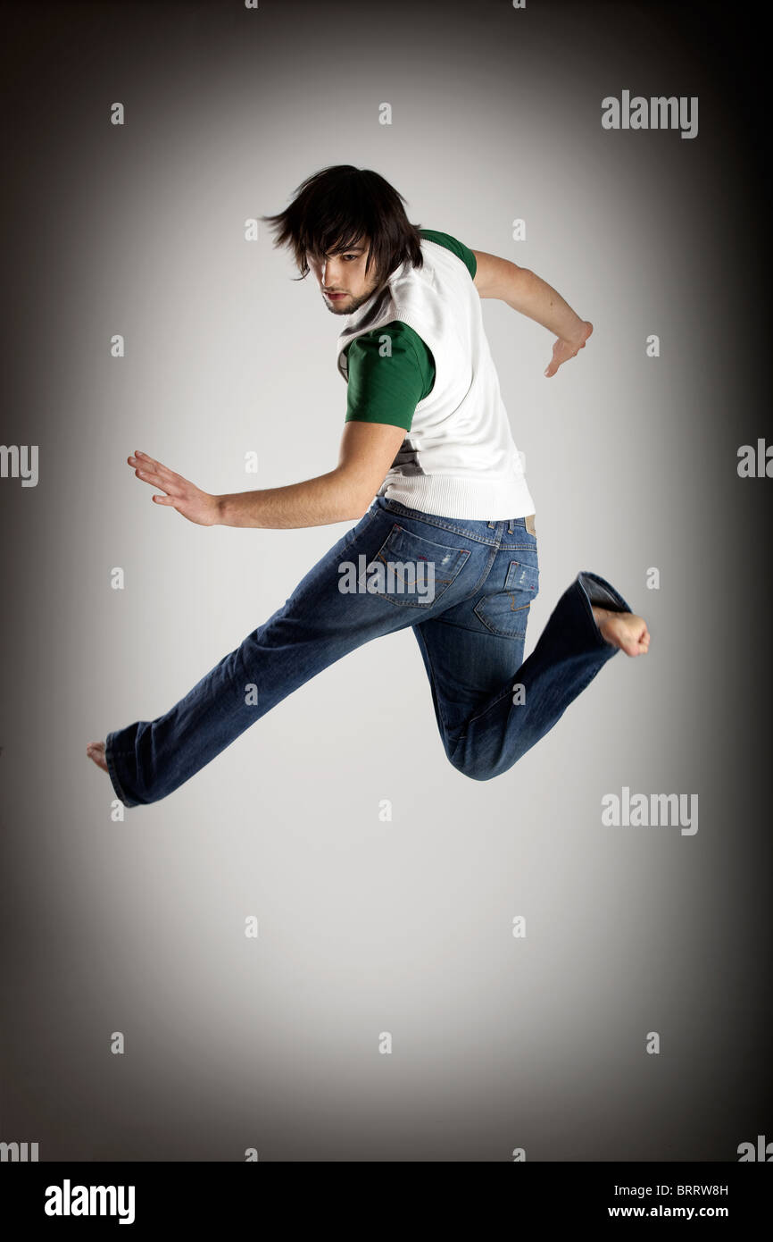Young modern man dancing over a white background Stock Photo - Alamy