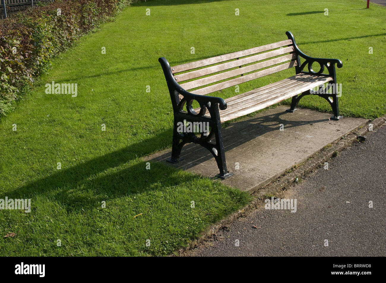 shadow lawn grass wooden bench seating sunny day Stock Photo - Alamy