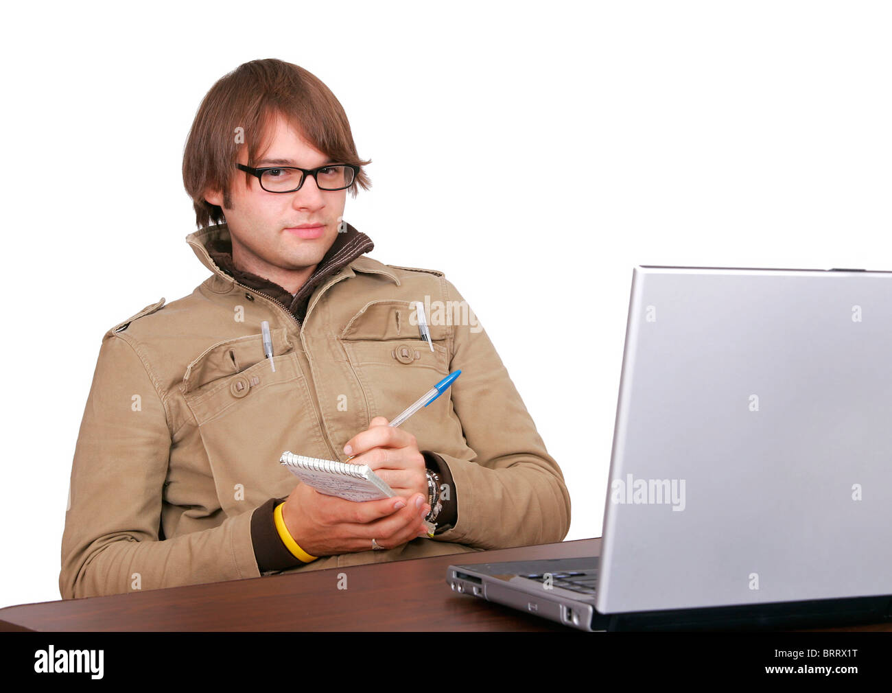 one man journalist reporter taking notes looking at a laptop computer ...