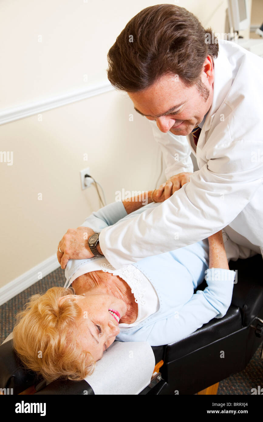 Senior woman gets relief from back pain when her chiropractor adjusts ...