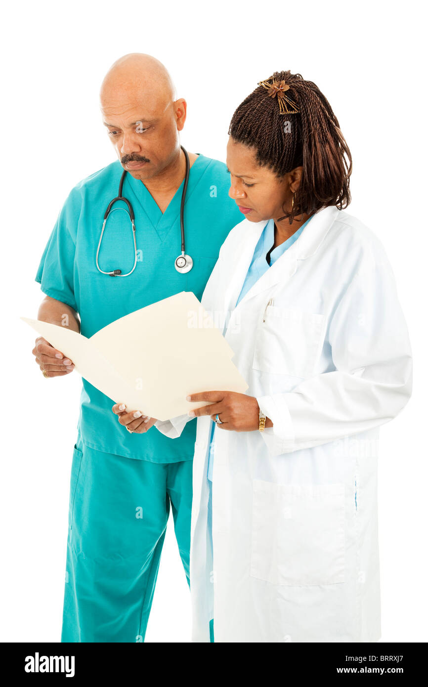 Two attractive African American doctors reading a patient's medical ...