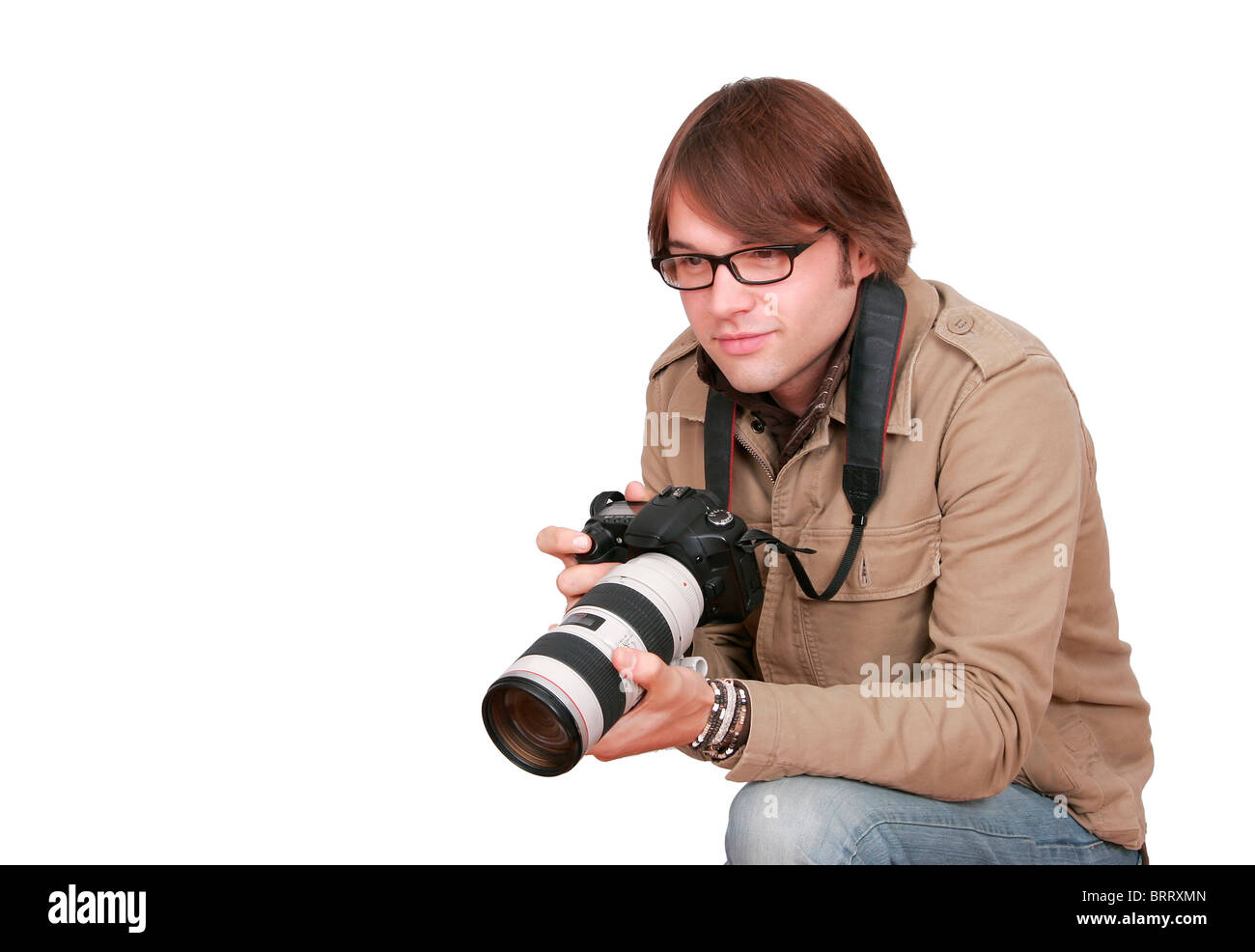 a young male photojournalist with a large camera over white Stock Photo ...