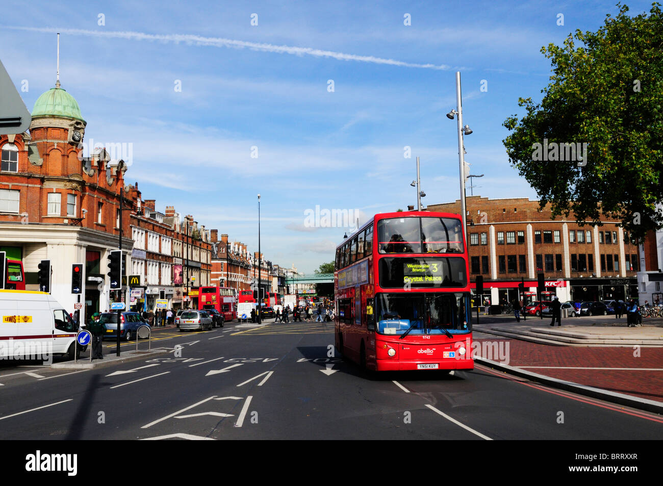 A red double decker bus on Brixton Road, Brixton, London, England, UK ...