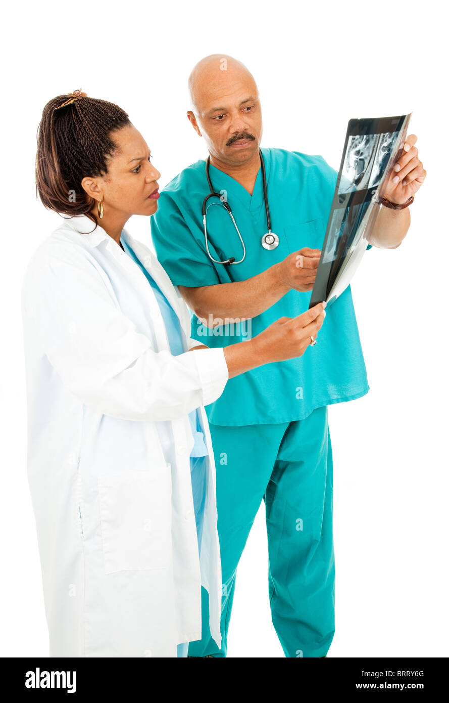 Serious African American doctors reviewing a patient's medical x-rays ...